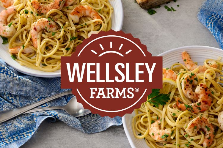 Wellsley Farms - Two pasta dishes with shrimp and garnish on a table ...